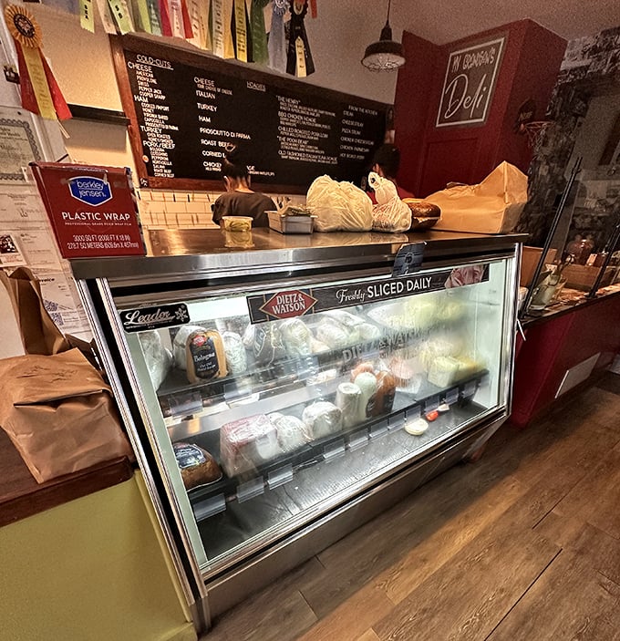 Behind the counter – where sandwich dreams come true and diet plans go to die, gloriously and without regret.