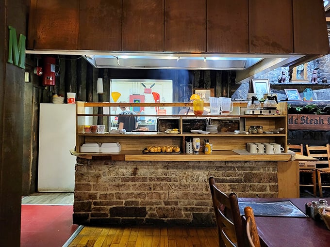 The pass-through window offers a glimpse into the kitchen's inner sanctum, where steak magic happens behind brick and wood.