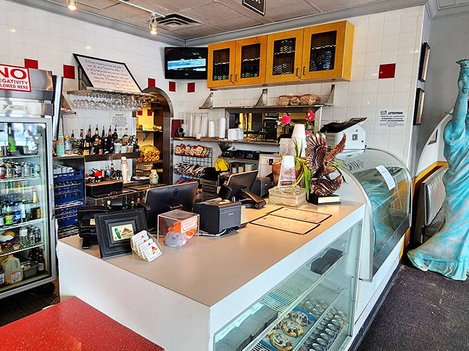 Behind the counter, where deli magic happens—a miniature Statue of Liberty stands guard, ensuring New York standards are maintained in Southern territory.