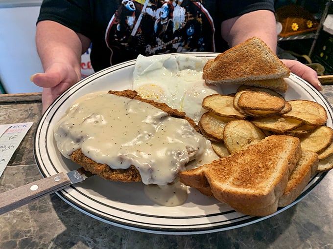 Country fried steak smothered in gravy with a side of home fries. Not just comfort food – it's a warm hug on a plate.