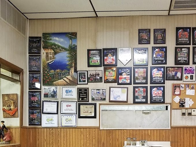 The wall of local sports memorabilia and community awards tells the story of a place that's more than a restaurant—it's a neighborhood cornerstone.