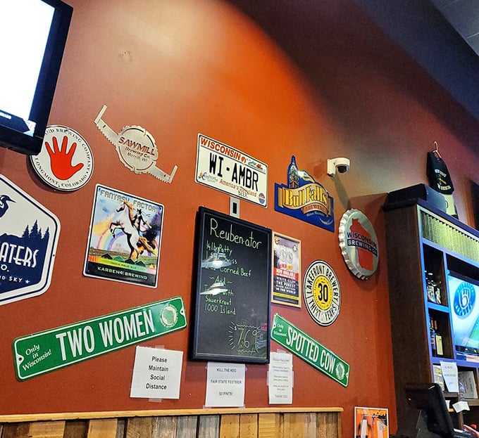 The wall of beer memorabilia and road signs – where "Two Women" and "Spotted Cow" aren't just Wisconsin beers, they're conversation starters.