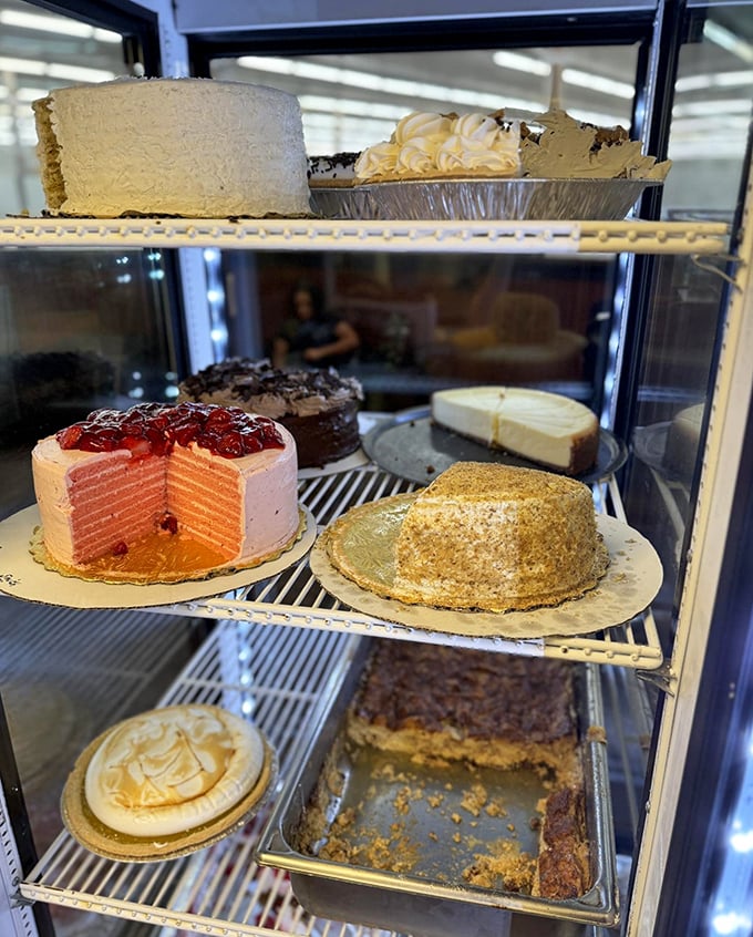 The dessert case – a glass-fronted museum of edible art where cakes and pies wait patiently for their moment of glory.