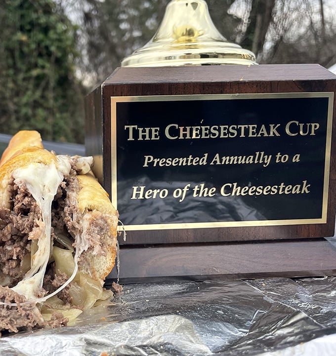 "The Cheesesteak Cup" sits proudly next to its inspiration—a trophy that celebrates not just a sandwich, but a cultural institution.
