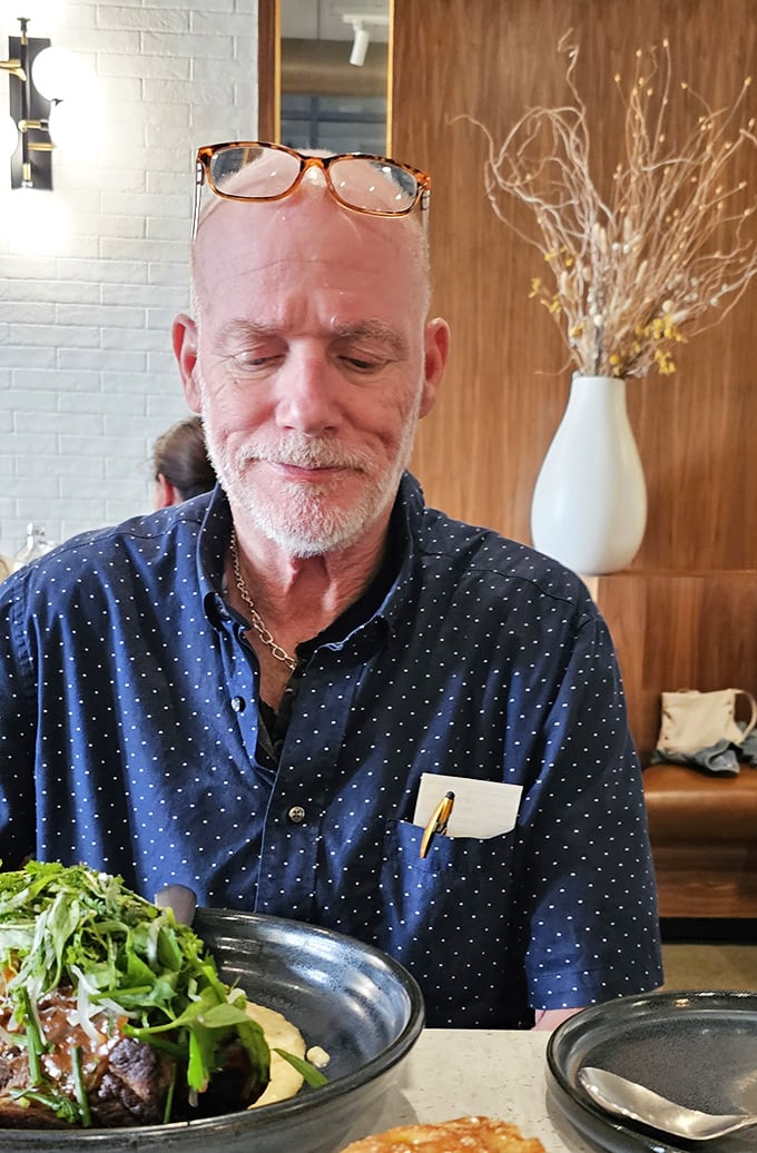 The look of someone experiencing Speck's cuisine for the first time—a moment of culinary revelation worth framing.
