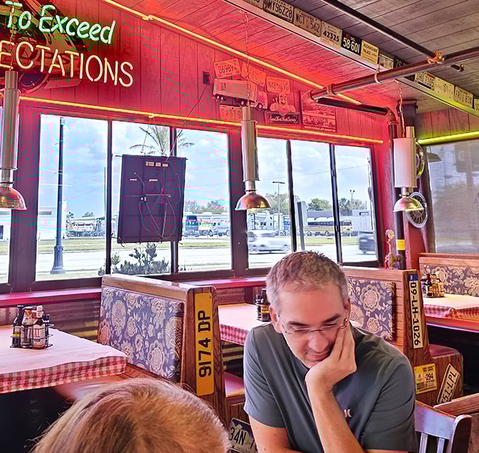 The neon "To Exceed Expectations" sign isn't just decoration—it's a mission statement illuminating comfortable booths where food memories are made.