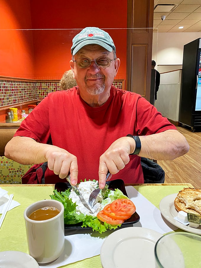 A happy diner points to his plate with the universal gesture that says, "This right here? This is what happiness tastes like."