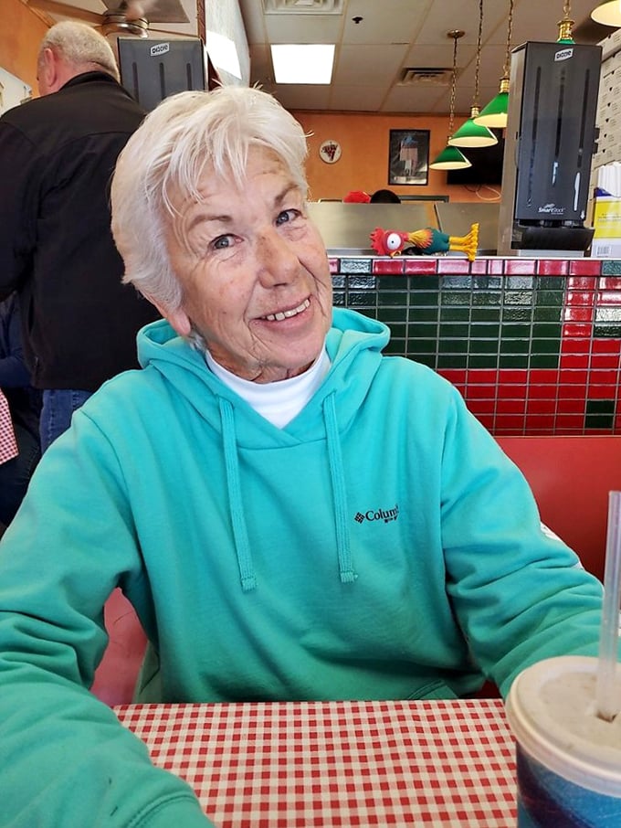 A moment of pure dining joy captured—the kind of genuine smile that only comes from a truly satisfying meal in a welcoming place.