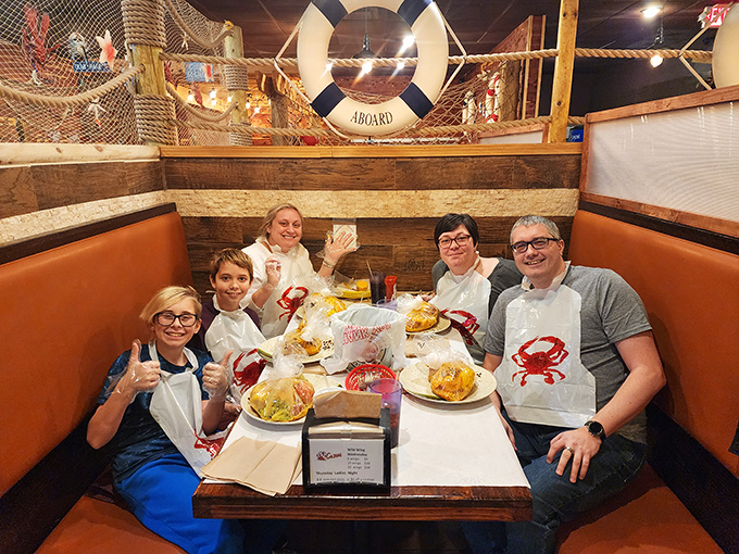 Happy diners sporting bibs and smiles—the universal uniform of people about to enjoy a seriously good seafood feast.
