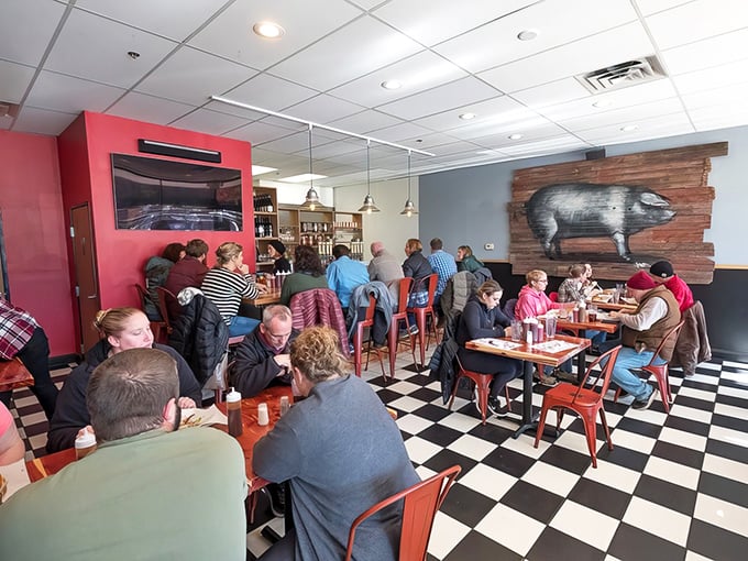 A packed house of happy diners under the watchful eye of the wooden pig – a scene that repeats daily in this meat-lovers' sanctuary.