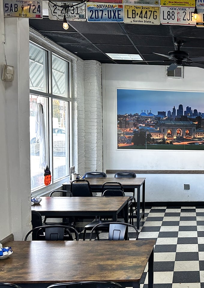 The dining area's simple charm comes with a side of civic pride—that Kansas City skyline watching over your meal like a metropolitan guardian angel.