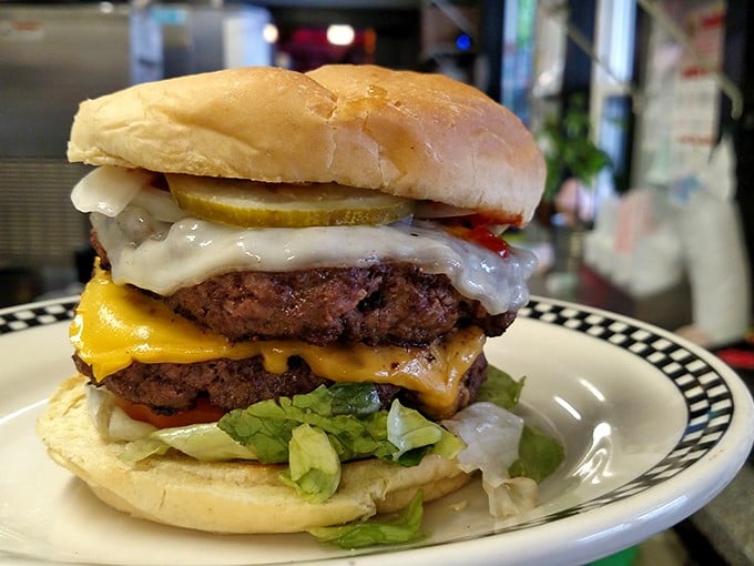 This isn't just a double cheeseburger—it's an architectural achievement. Layers of beef, cheese, and fresh toppings stacked higher than your cardiologist's blood pressure.