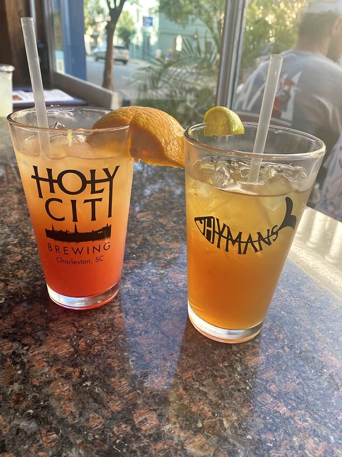 Two refreshing drinks with citrus garnishes—liquid sunshine in glasses that promise to cool you down after a day of Charleston exploration.