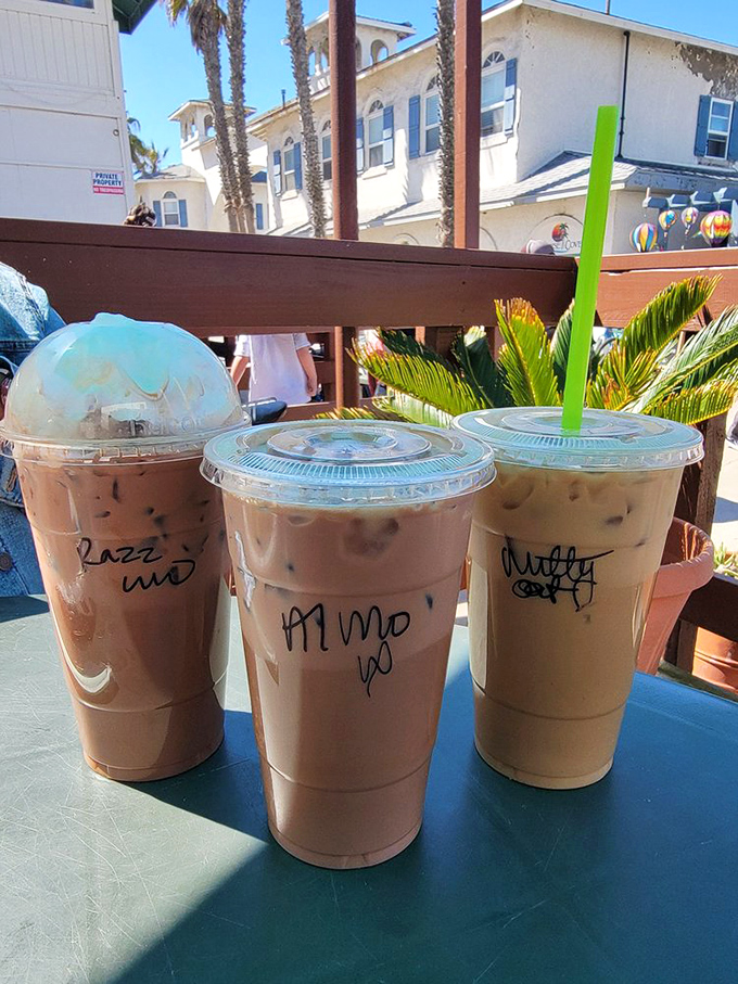 Iced coffees with personality—each cup labeled with the kind of casual scrawl that says "we're too busy making great coffee to worry about penmanship."
