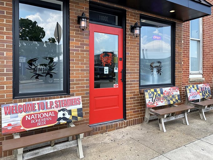 The welcoming red door and benches outside invite you into a world where crab is king and Old Bay is the crown.
