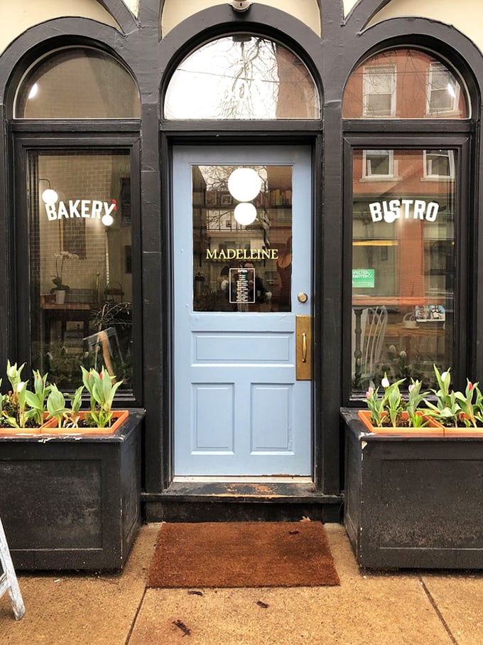 The pale blue door between "BAKERY" and "BISTRO" isn't just an entrance—it's a portal to a world where butter is sacred and patience is rewarded.