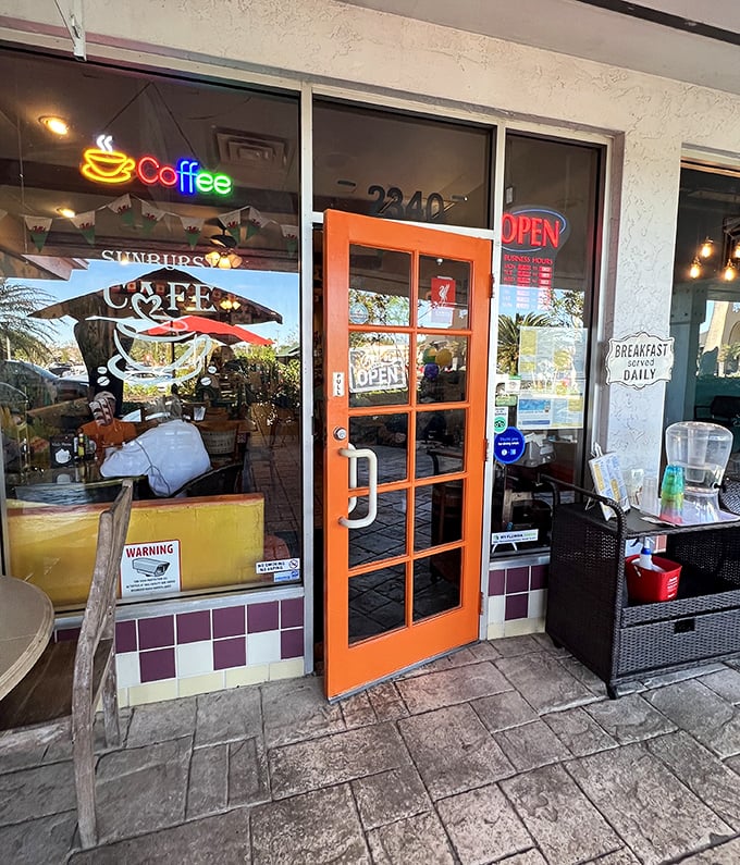 The orange door to breakfast bliss. This welcoming entrance has ushered in thousands of hungry patrons, many still dreaming of coffee as they cross the threshold.
