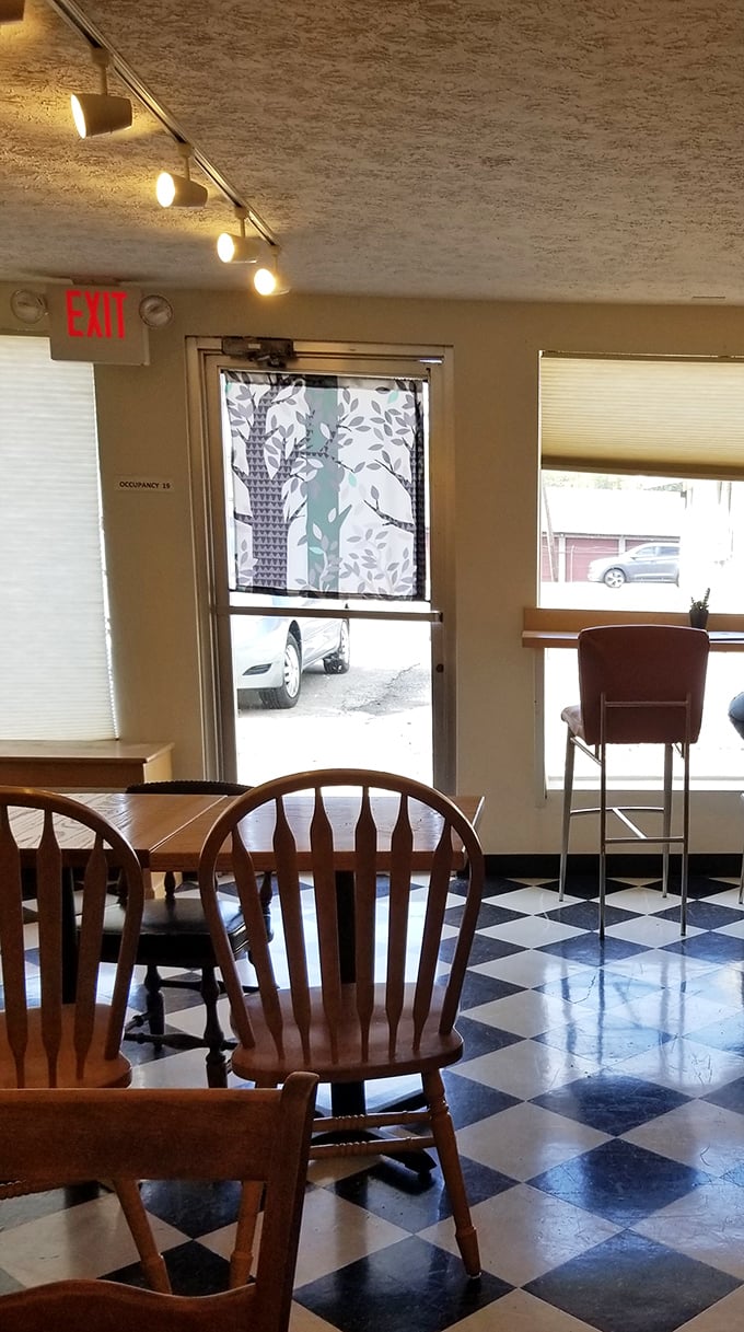 Simple furnishings that invite you to linger. That tree-patterned window covering adds just the right touch of whimsy to this bread sanctuary.