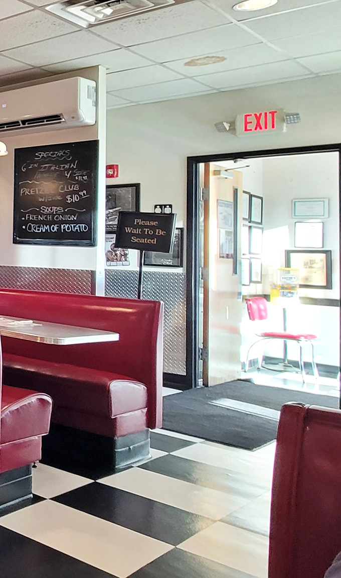 The "Please Wait To Be Seated" sign—diner code for "good things come to those who wait." Specials on the chalkboard hint at today's treasures.