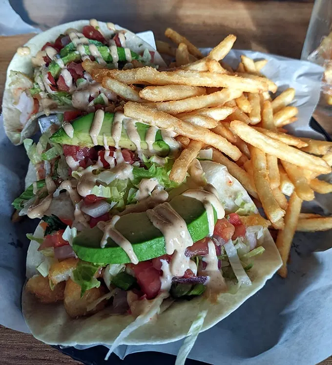 Fish tacos that deserve their own flight plan—crispy, fresh, and adorned with vibrant toppings that create a perfect harmony of textures and flavors.