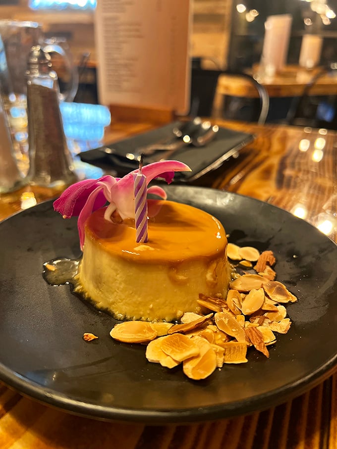 A flan that jiggles with confidence, crowned with caramel and surrounded by almond shards like a dessert wearing its Sunday best.