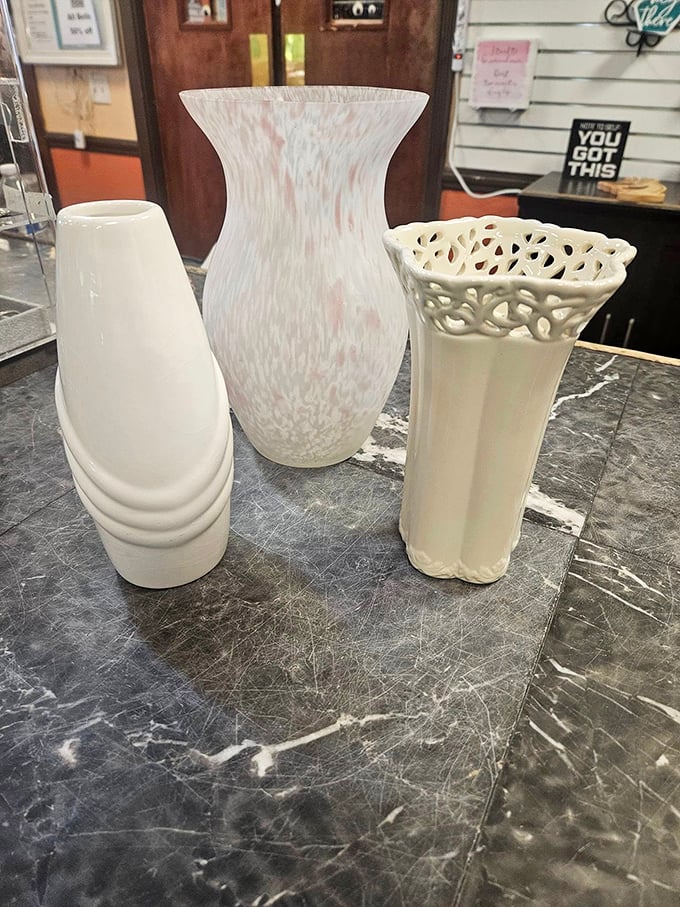 Elegant vases awaiting their flower destiny. One person's decluttered shelf becomes another's statement piece – the circle of thrift store life.