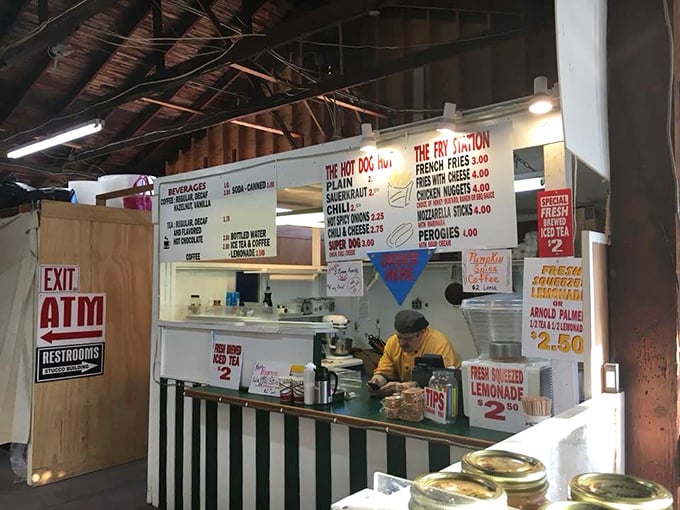 The market's food stand menu board promises simple pleasures: hot dogs, fries, and lemonade—fuel for serious treasure hunting ahead.