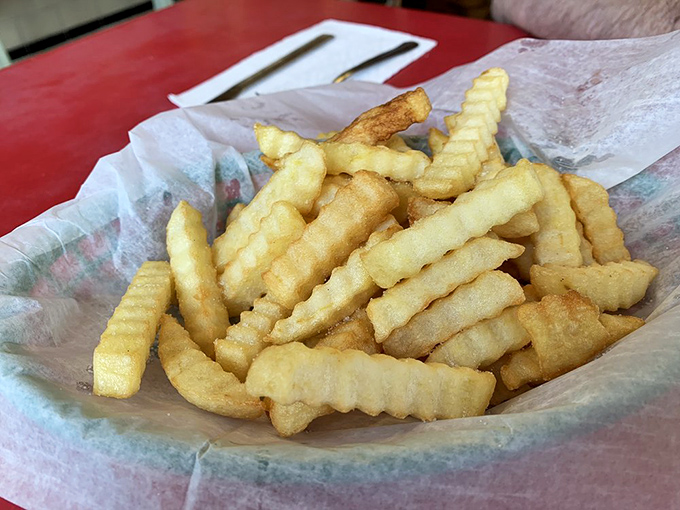 Crinkle-cut fries served in paper – crispy, golden, and unpretentious, the perfect companion to any diner meal or worthy of devotion all on their own.