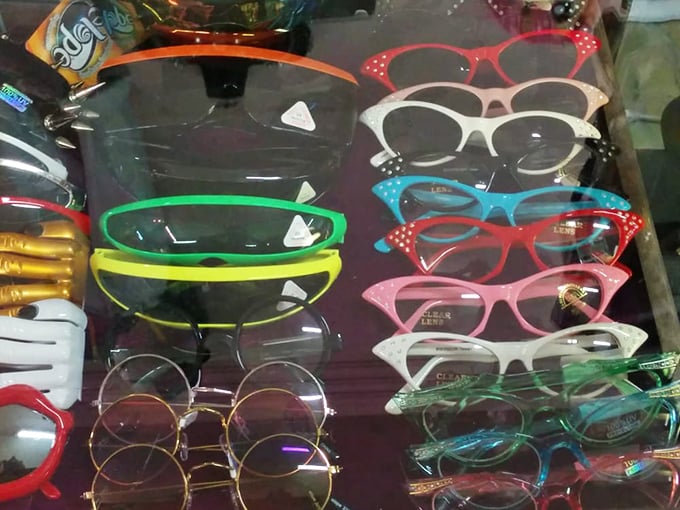 Cat-eye frames in candy colors sit alongside John Lennon circles—eyewear that sees the world through decades of style.
