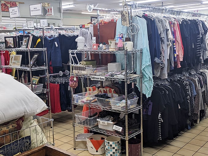 Clothing racks organized by size and type – a rare luxury in thrift store shopping that makes finding your style both possible and pleasant.