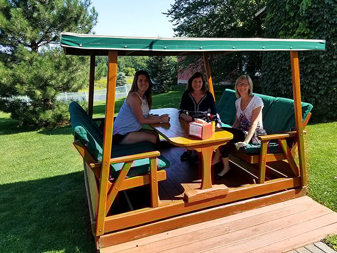 The glider dining experience—where gentle swinging meets serious eating. Somehow food tastes better when you're gently rocking in the Michigan breeze.