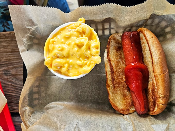 The humble hot dog gets the royal treatment here, paired with mac and cheese that's practically glowing with cheesy goodness.