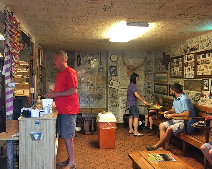 Inside Herd's, the dance of diners and staff plays out against a backdrop of wall signatures—a choreography perfected over decades of burger service.