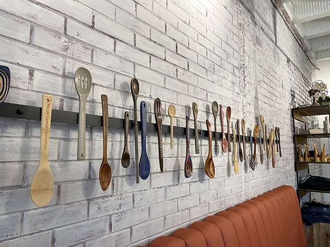 Wooden spoons line the wall like badges of honor – each one representing countless meals that have changed more than just hunger.