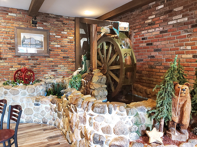 A whimsical water wheel and stone wall create a slice of country charm inside—dining ambiance that transports you to simpler times.