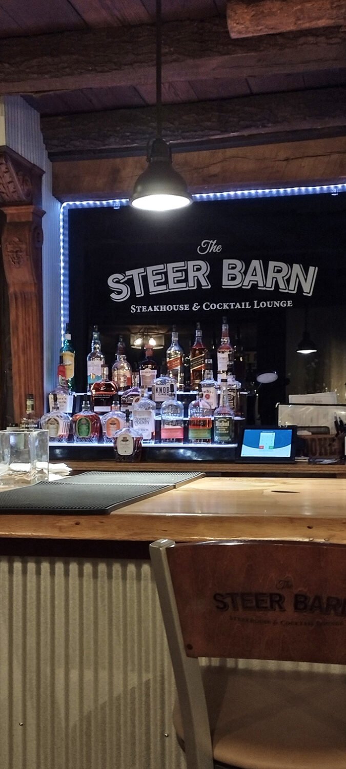 The bar's rustic-industrial aesthetic isn't trying too hard—it's just confident enough to let the spirits and conversation take center stage.