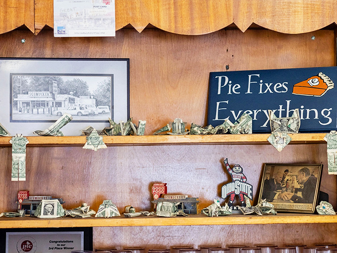 "Pie Fixes Everything" – the sign speaks truth while dollar bills and Ohio State memorabilia create a shrine to local pride.
