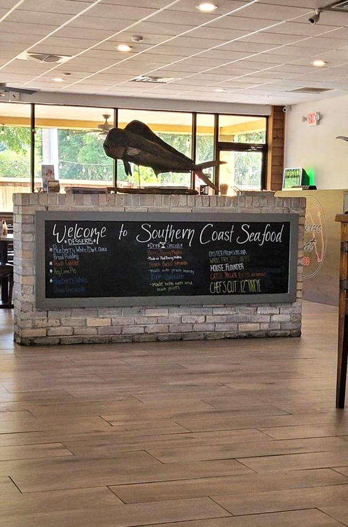 The welcome desk doubles as a mission statement – a stone and chalkboard declaration that fresh seafood is serious business here.