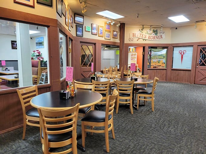 Bette's Korner offers a quieter dining option where wooden tables and chairs await beneath framed local artwork—a breakfast sanctuary within a sanctuary.