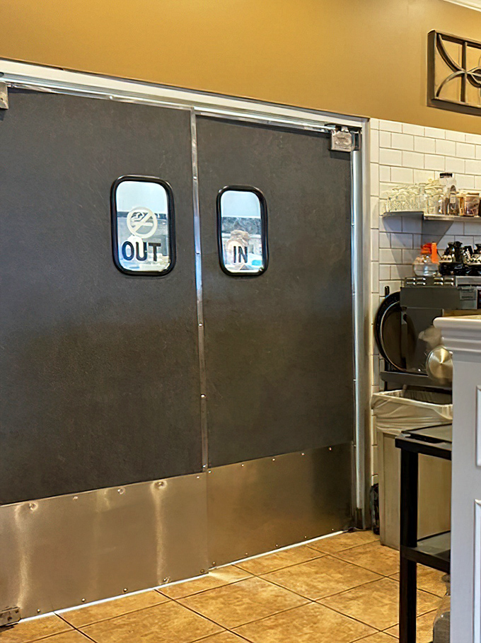 Kitchen doors marked "IN" and "OUT"—a simple system ensuring your breakfast emerges from organized chaos rather than just chaos.