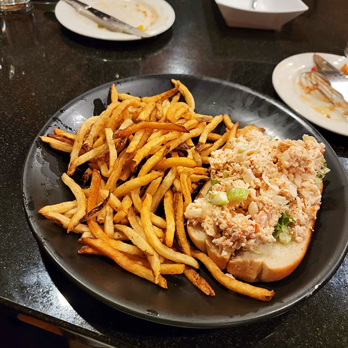 The classic lobster roll gets the respect it deserves – simple, generous, and paired with fries that look hand-cut by someone who cares.
