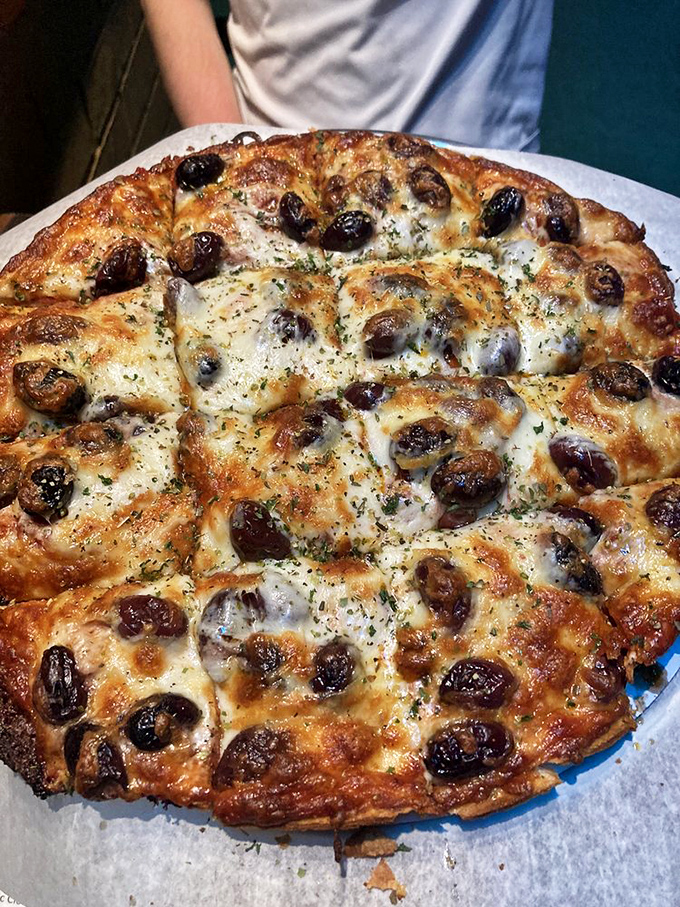 The mushroom pizza showcases how a single ingredient, when respected, becomes the star. Those roasted beauties aren't toppings – they're the main event.