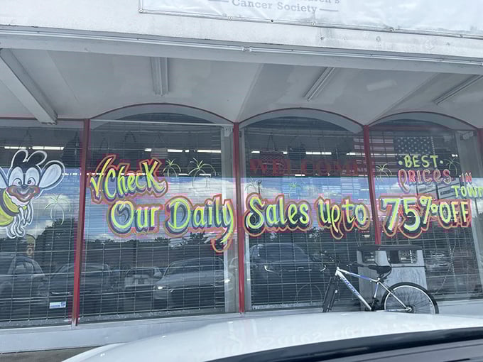 Window signage promising discounts up to 75% off—the siren song of thrift stores that turns casual browsers into dedicated treasure hunters.