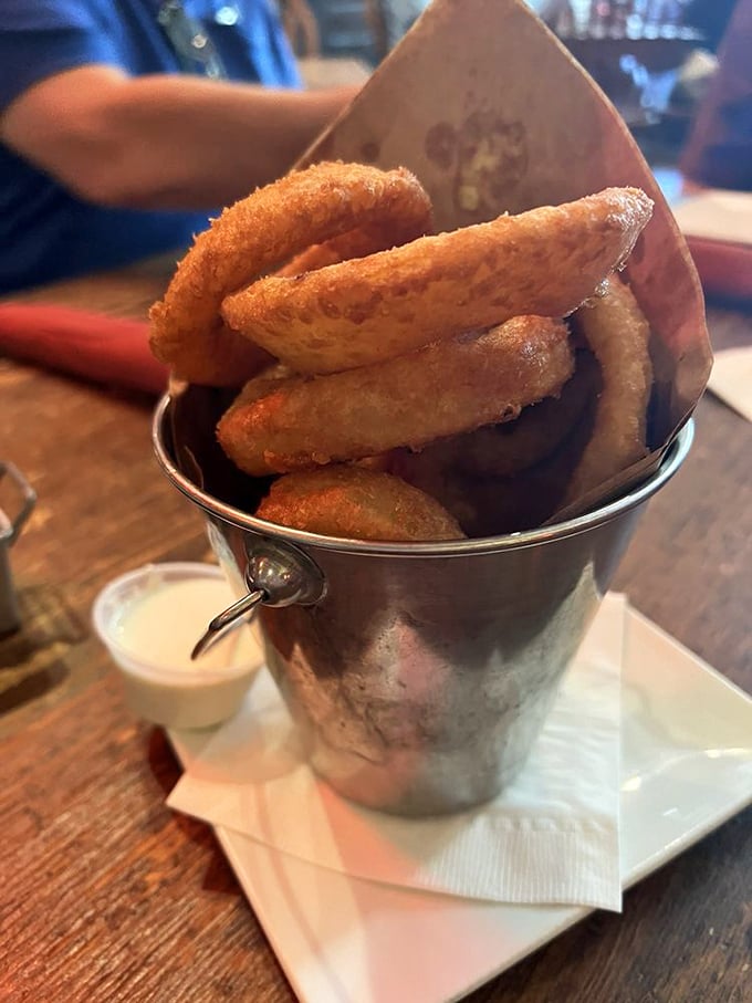 Onion rings stacked like gold nuggets in a prospector's pail—crispy, golden treasures that strike it rich in the flavor department.