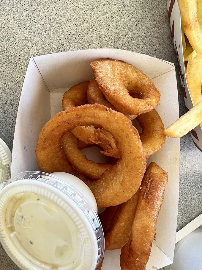 Onion rings with the perfect crunch-to-give ratio—where the humble onion transforms into golden hoops of happiness.