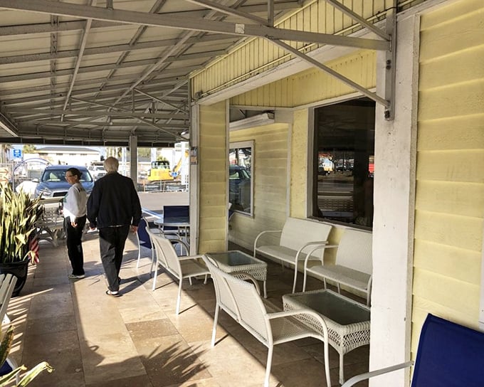The covered porch where breakfast anticipation builds. Those white chairs have heard more "I'm so hungry" conversations than any therapist.