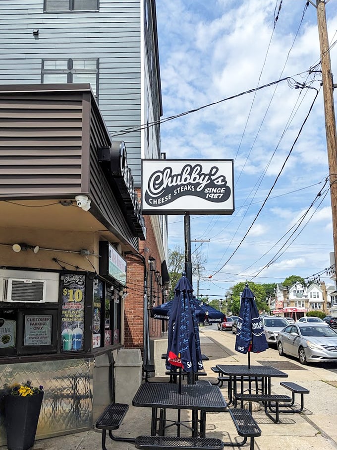 Outdoor seating under Labatt Blue umbrellas – because sometimes you need fresh air to fully appreciate the magnitude of the sandwich you're about to tackle.
