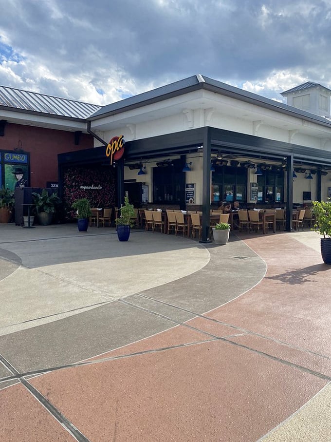 The outdoor seating area offers a more serene alternative to the indoor festivities—at least until someone orders the flaming saganaki at the next table.