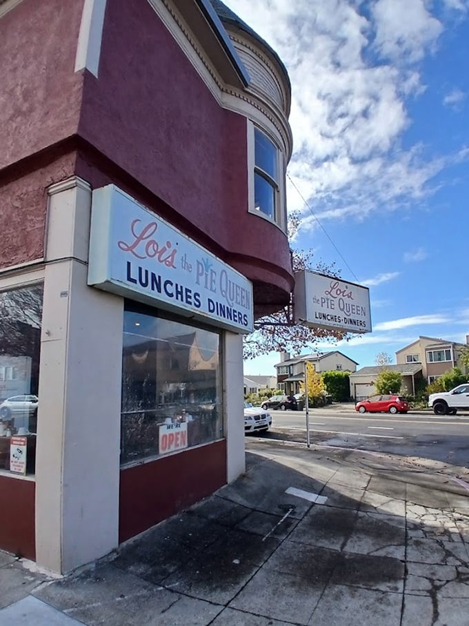 The corner spot that's witnessed decades of Oakland life – standing proud in its burgundy coat like a neighborhood guardian.