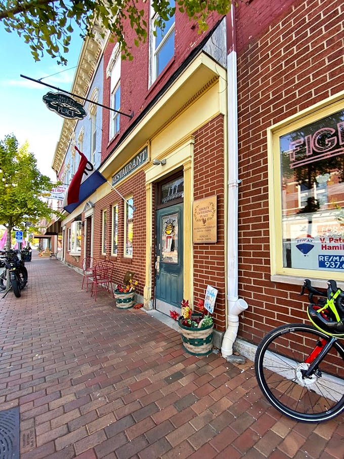 The storefront exudes small-town charm with its brick sidewalk and blue door – like something from a movie where the protagonist finds themselves again.